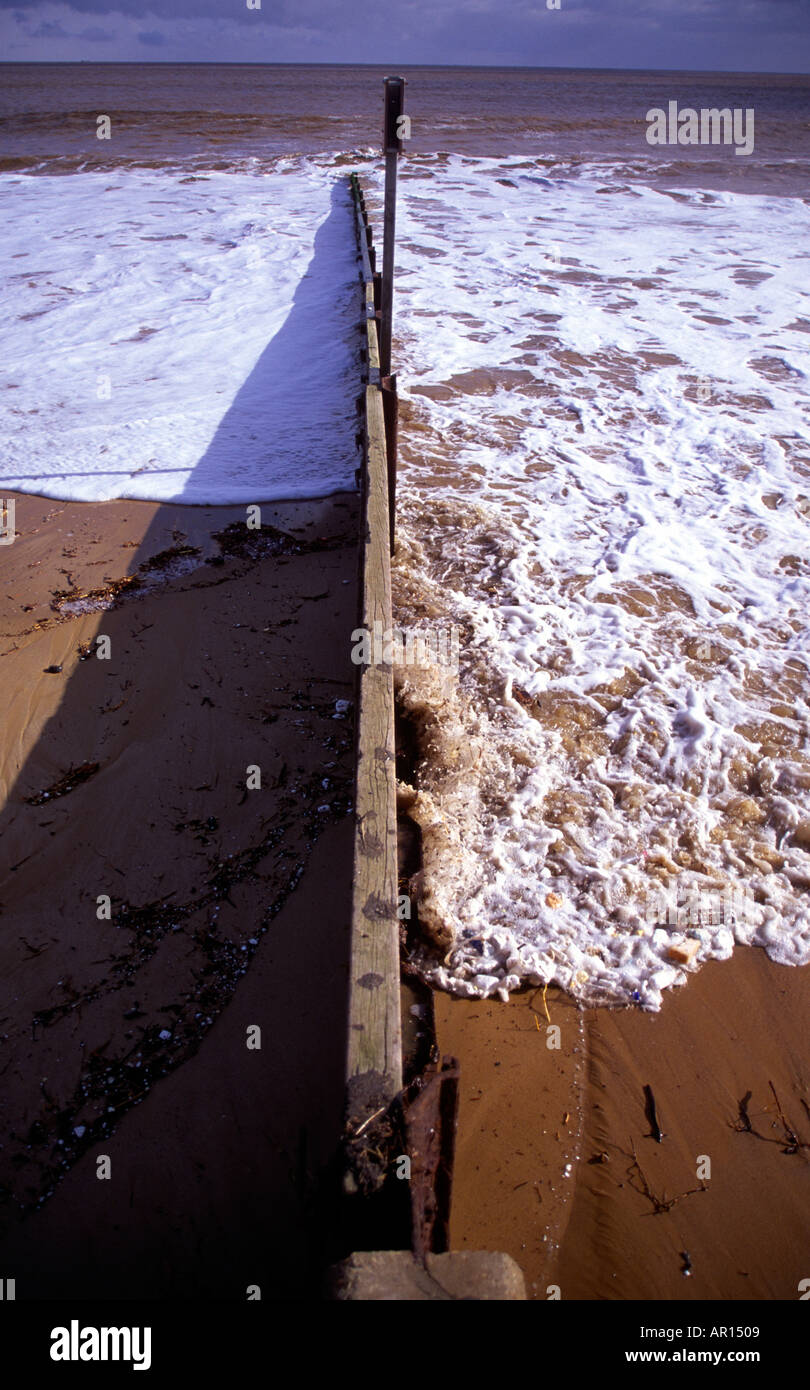 Waves beach and groyne Stock Photo - Alamy