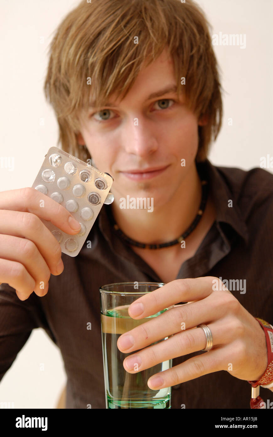 Man takes tablets Stock Photo - Alamy