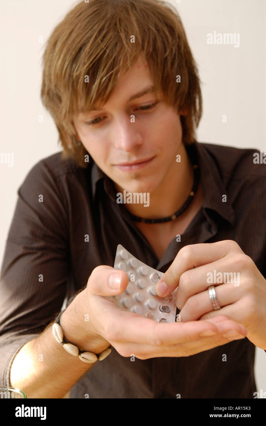 Man takes tablets Stock Photo - Alamy