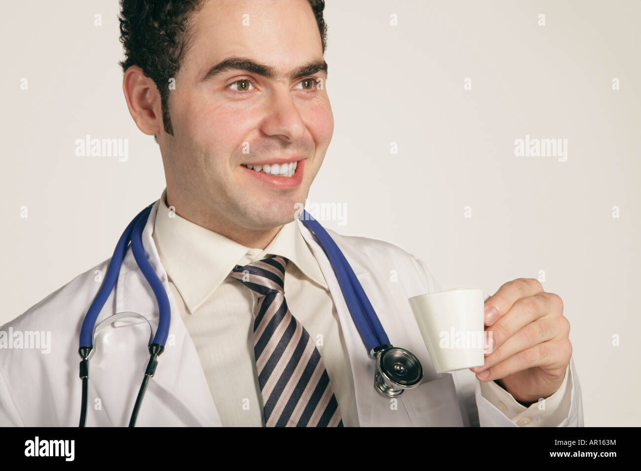 Doctor smiles with tea cup Stock Photo - Alamy