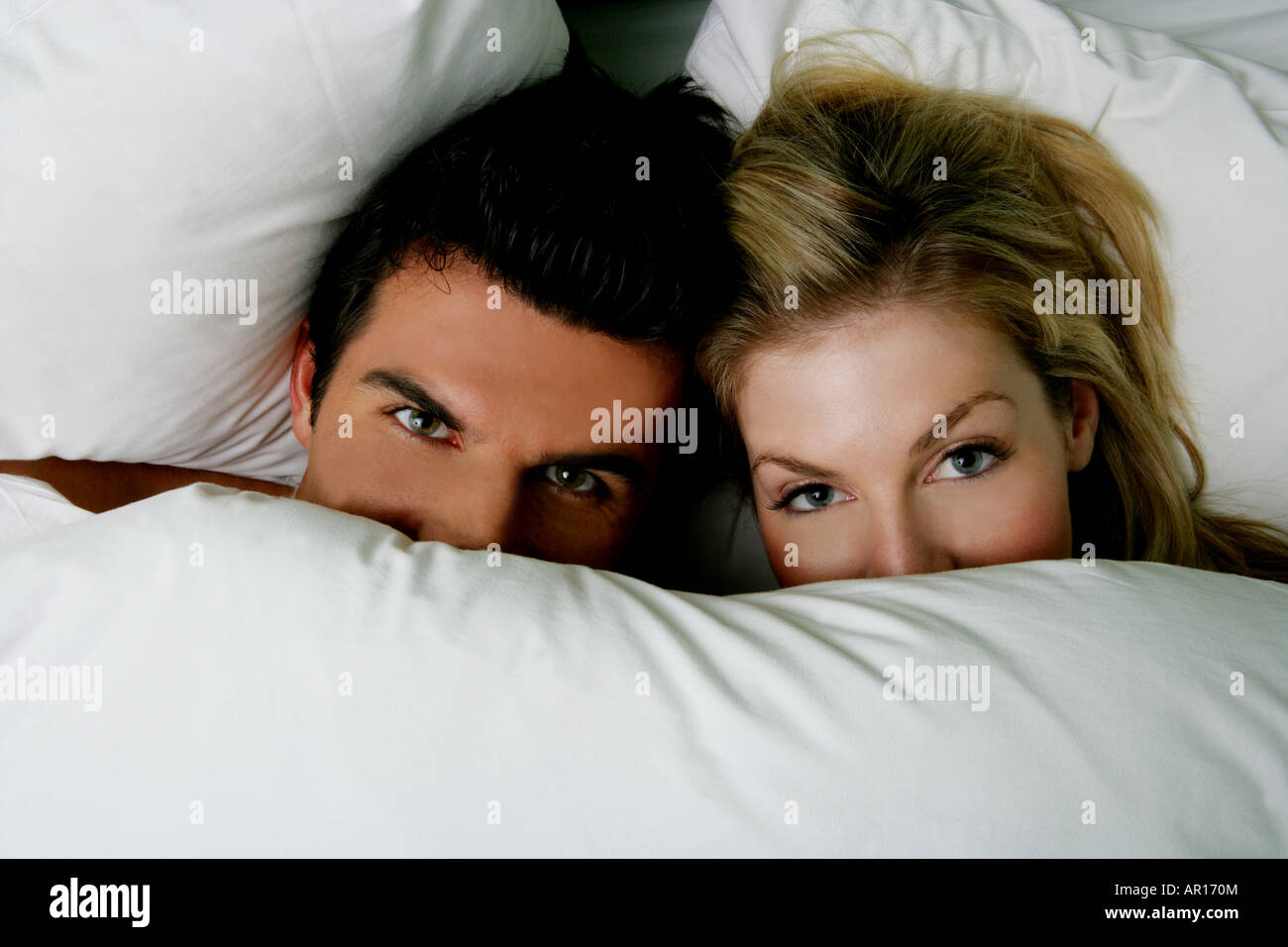 Man looking under covers bed hi-res stock photography and images - Alamy