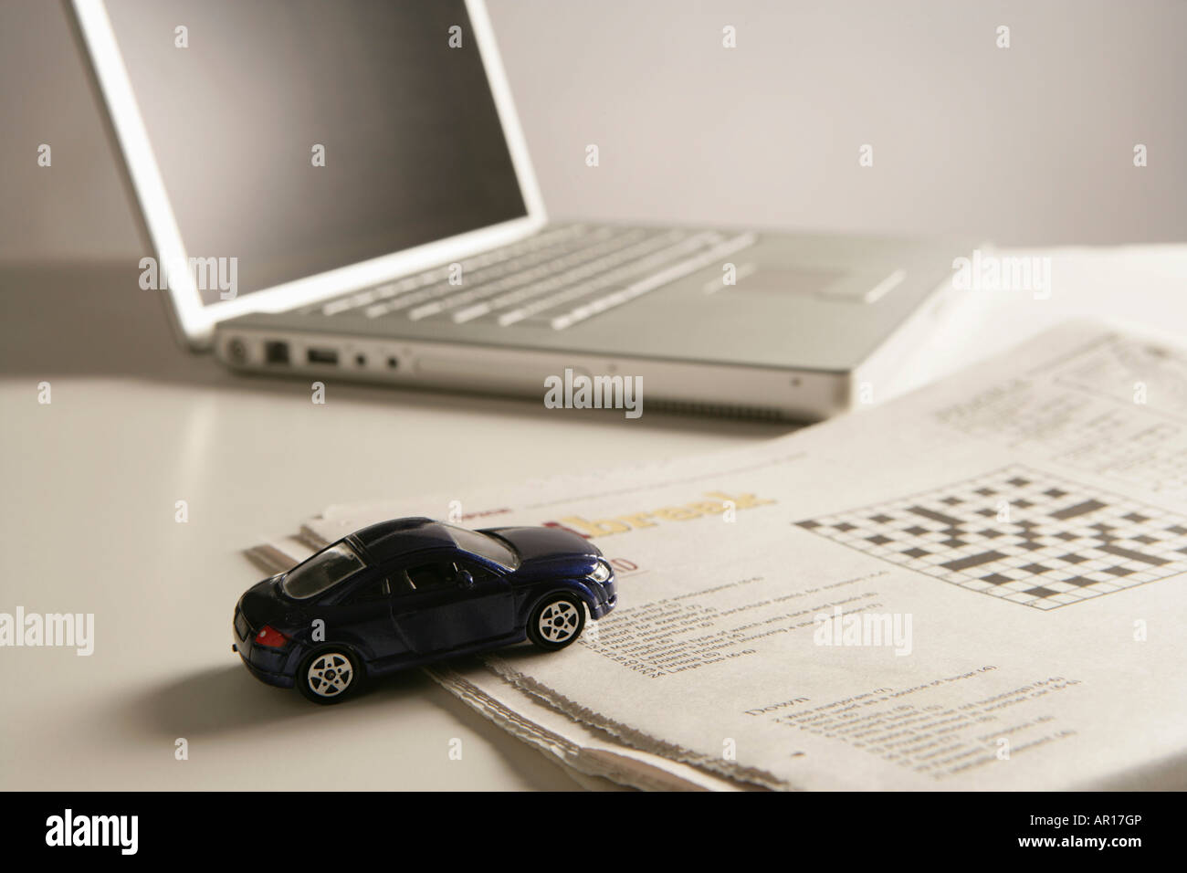 Car on a newspaper with Laptop Stock Photo - Alamy