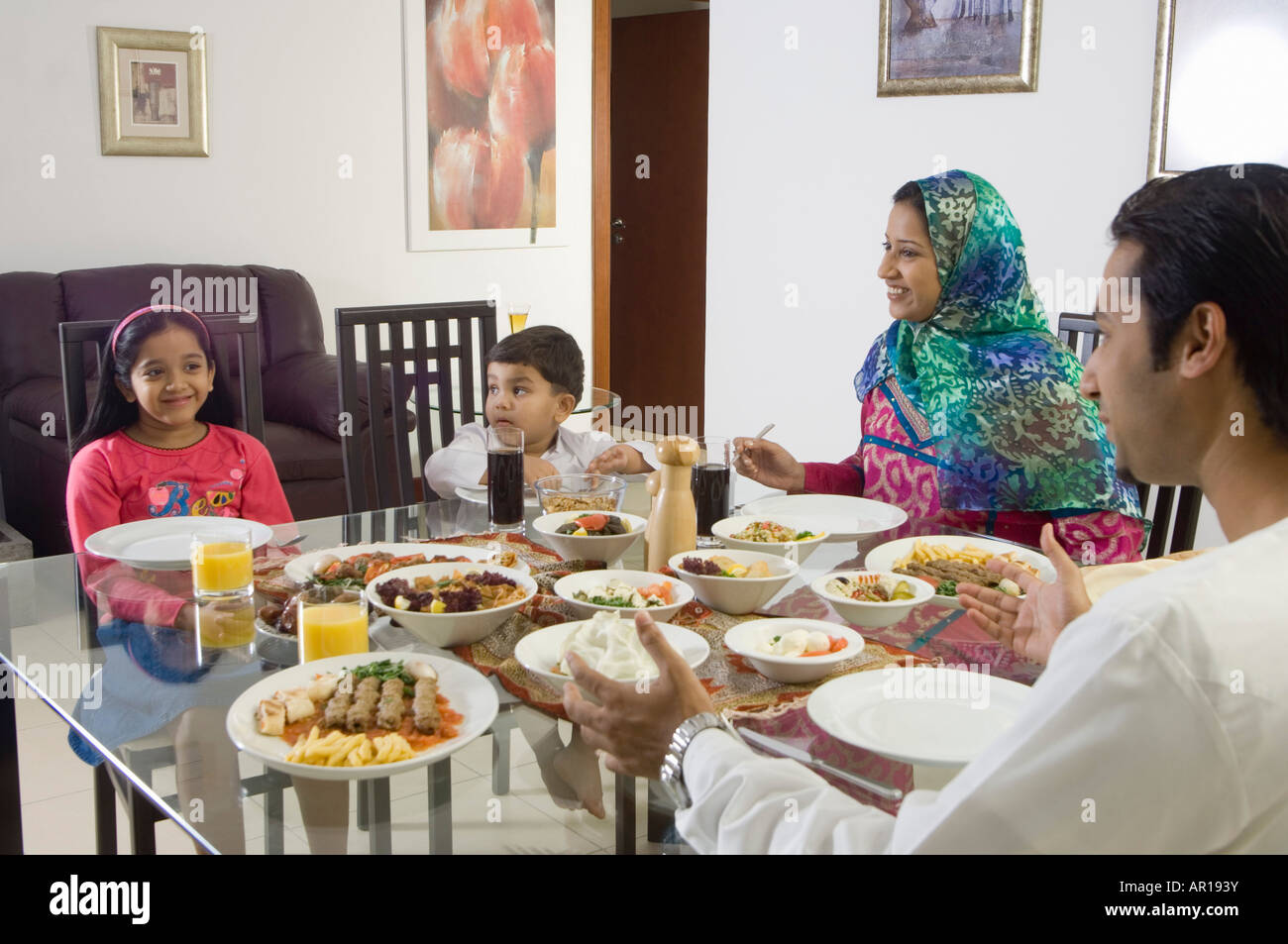 Arab Family of four dining Stock Photo - Alamy