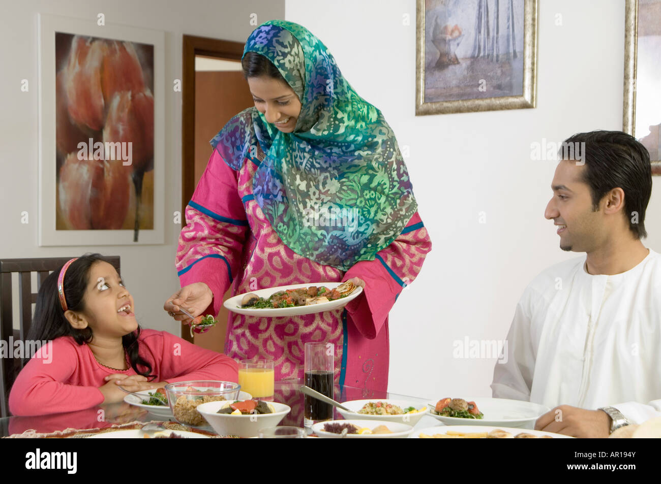 Woman eating table head scarf hi-res stock photography and images - Alamy