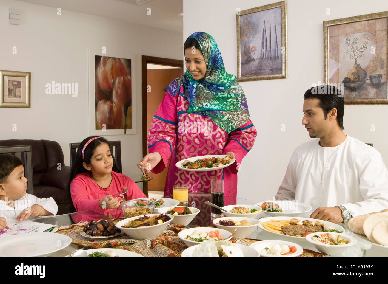 Mother serving food to family Stock Photo - Alamy