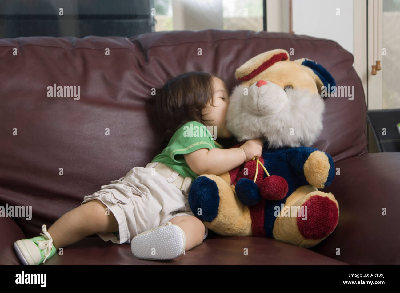 Baby boy with a soft toy Stock Photo - Alamy