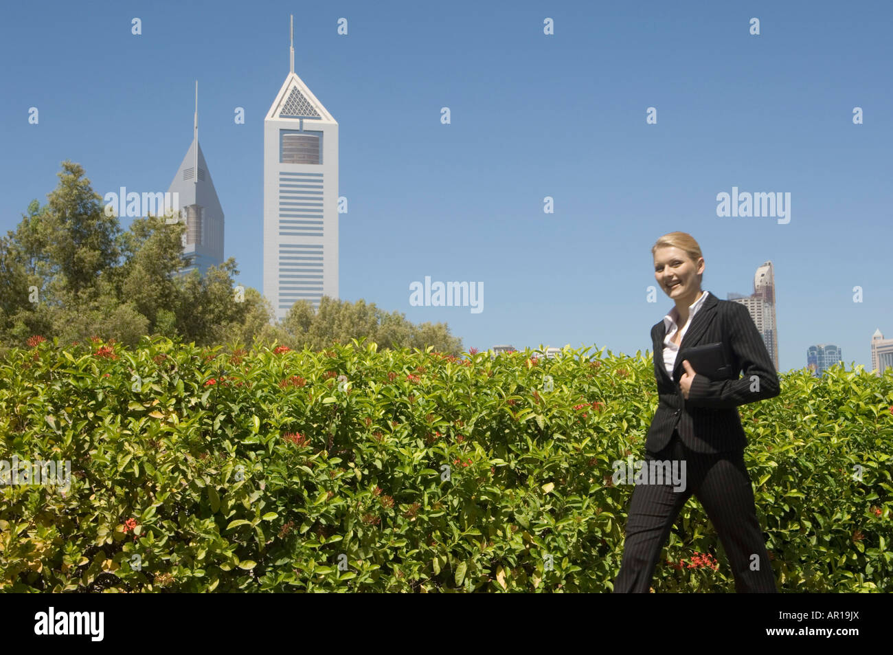 Young Businesswoman outdoors with modern office towers seen in the ...