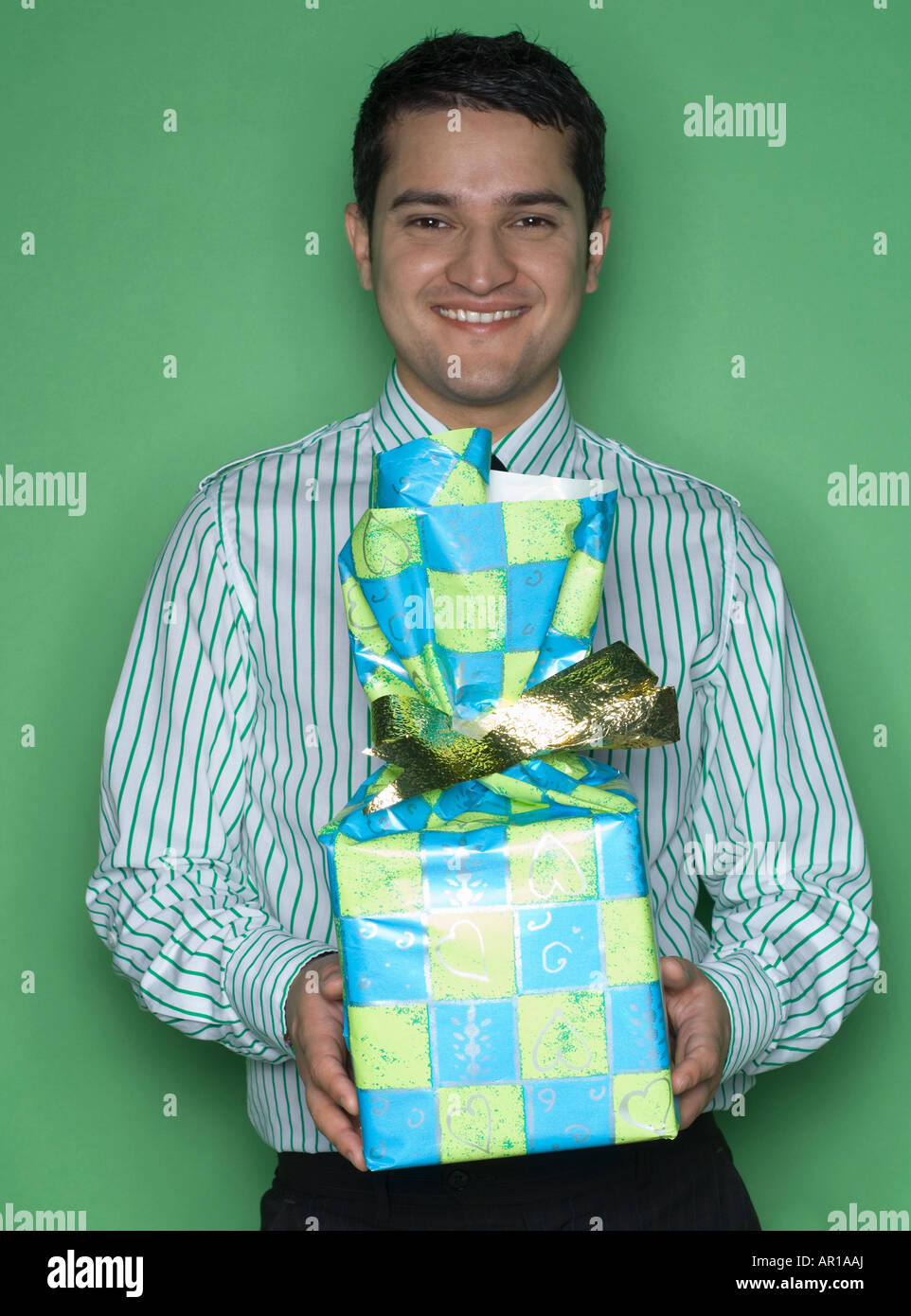 Young man holding a present Stock Photo - Alamy