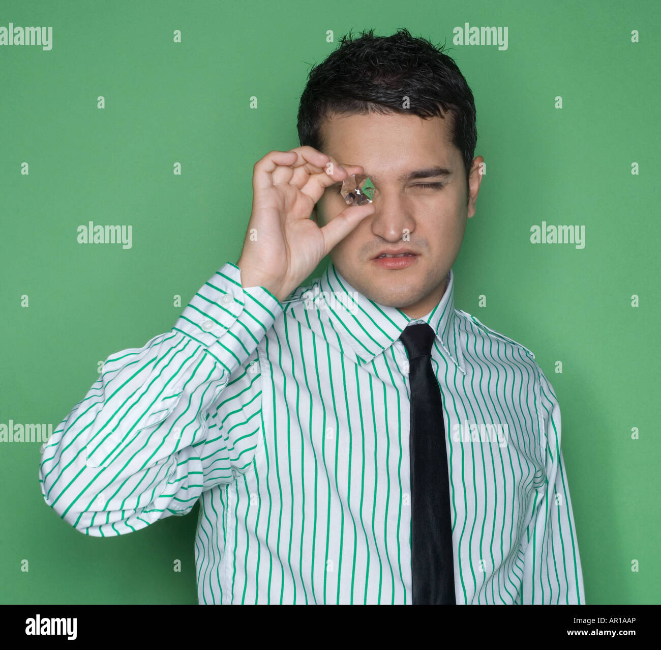 Young man looking through stone Stock Photo - Alamy