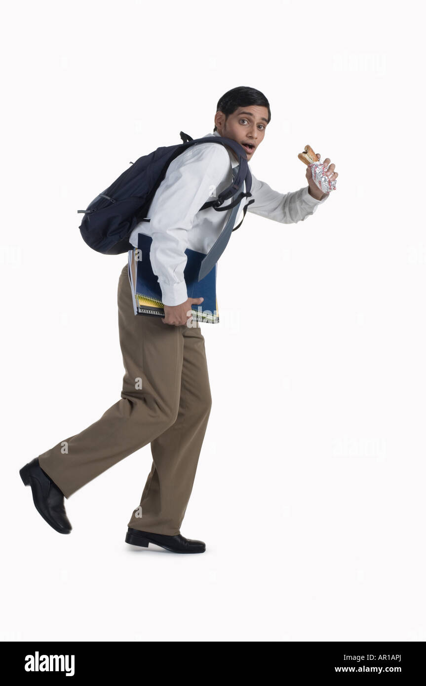 Young businessman with backpack running, portrait Stock Photo - Alamy
