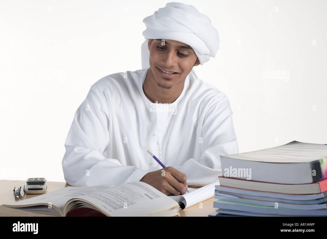Young man writing, smiling Stock Photo - Alamy