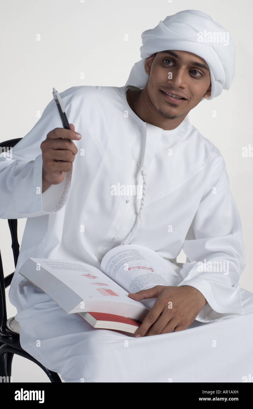 Young man writing, smiling Stock Photo - Alamy