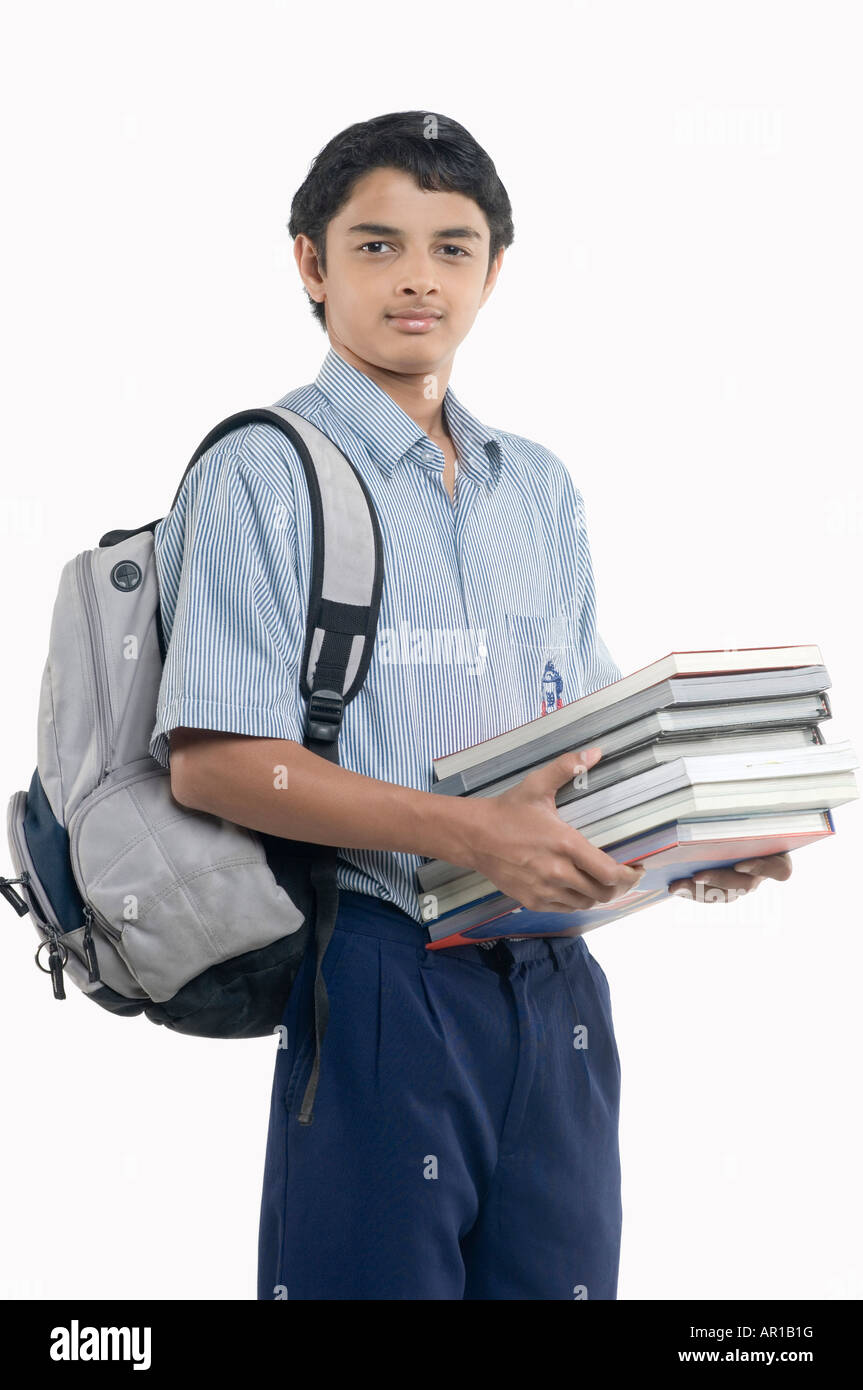 Teenage boy carrying books Stock Photo - Alamy