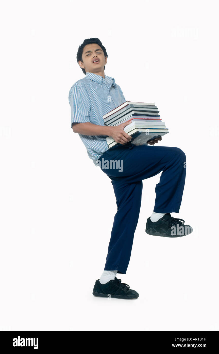 Teenage boy carrying books Stock Photo - Alamy