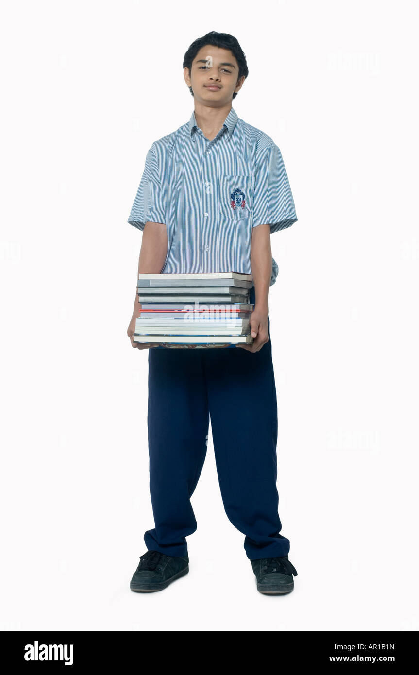 Teenage boy carrying books Stock Photo - Alamy