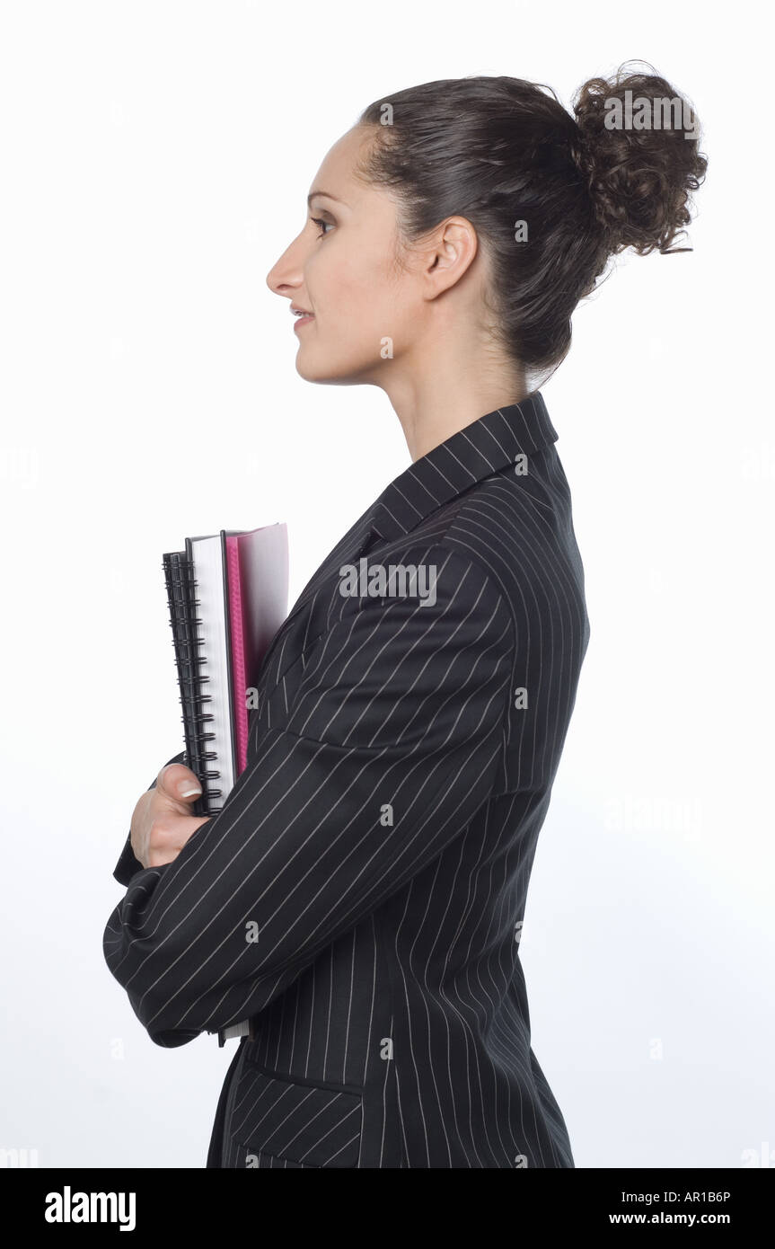 Young woman holding file, side view Stock Photo - Alamy