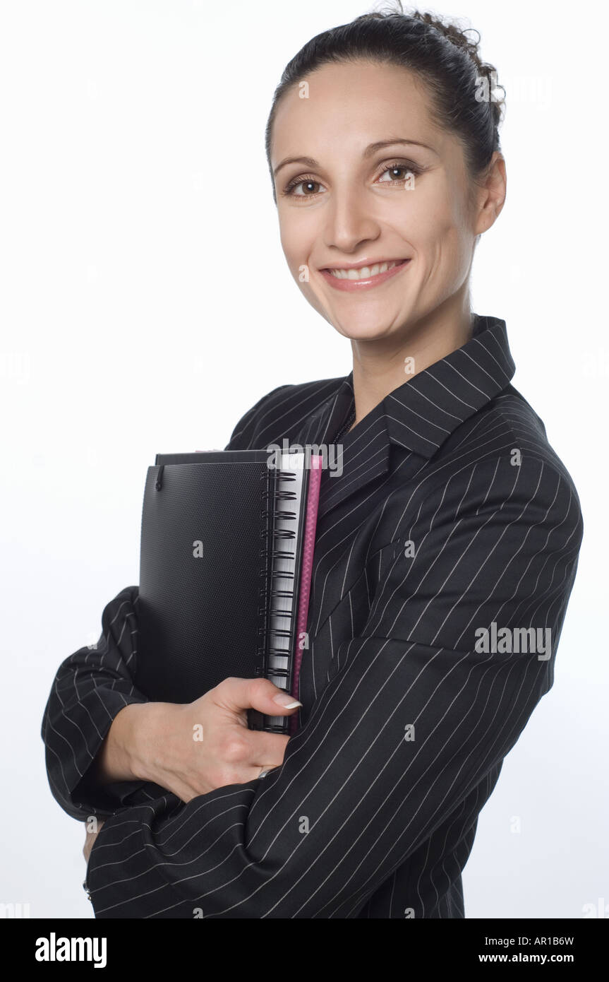 Young woman holding file, portrait Stock Photo - Alamy