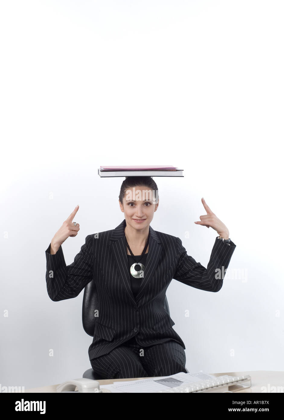 Young woman balancing book on head, portrait Stock Photo - Alamy