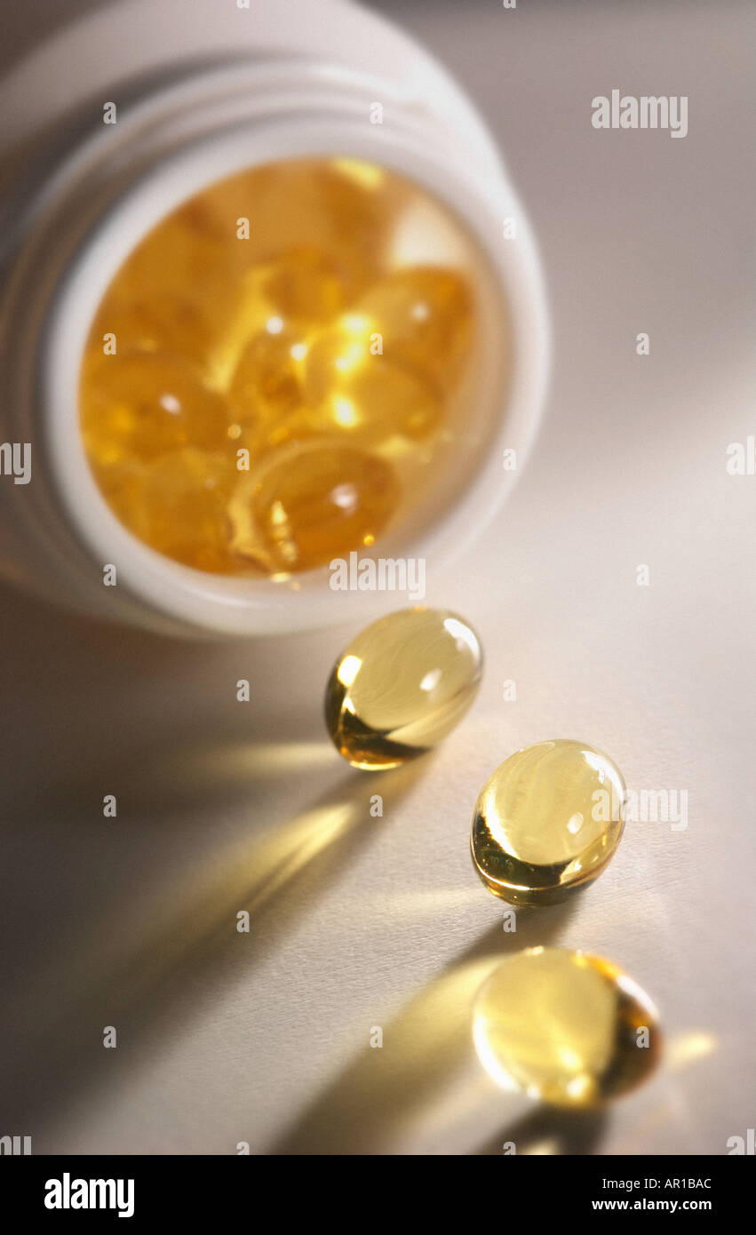 Capsules coming out of white plastic tub Stock Photo - Alamy