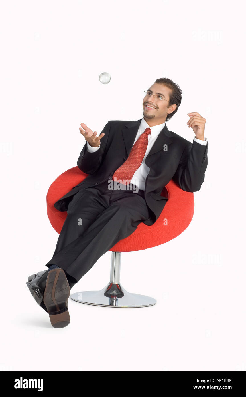 Businessman playing with paperweight hi-res stock photography and ...