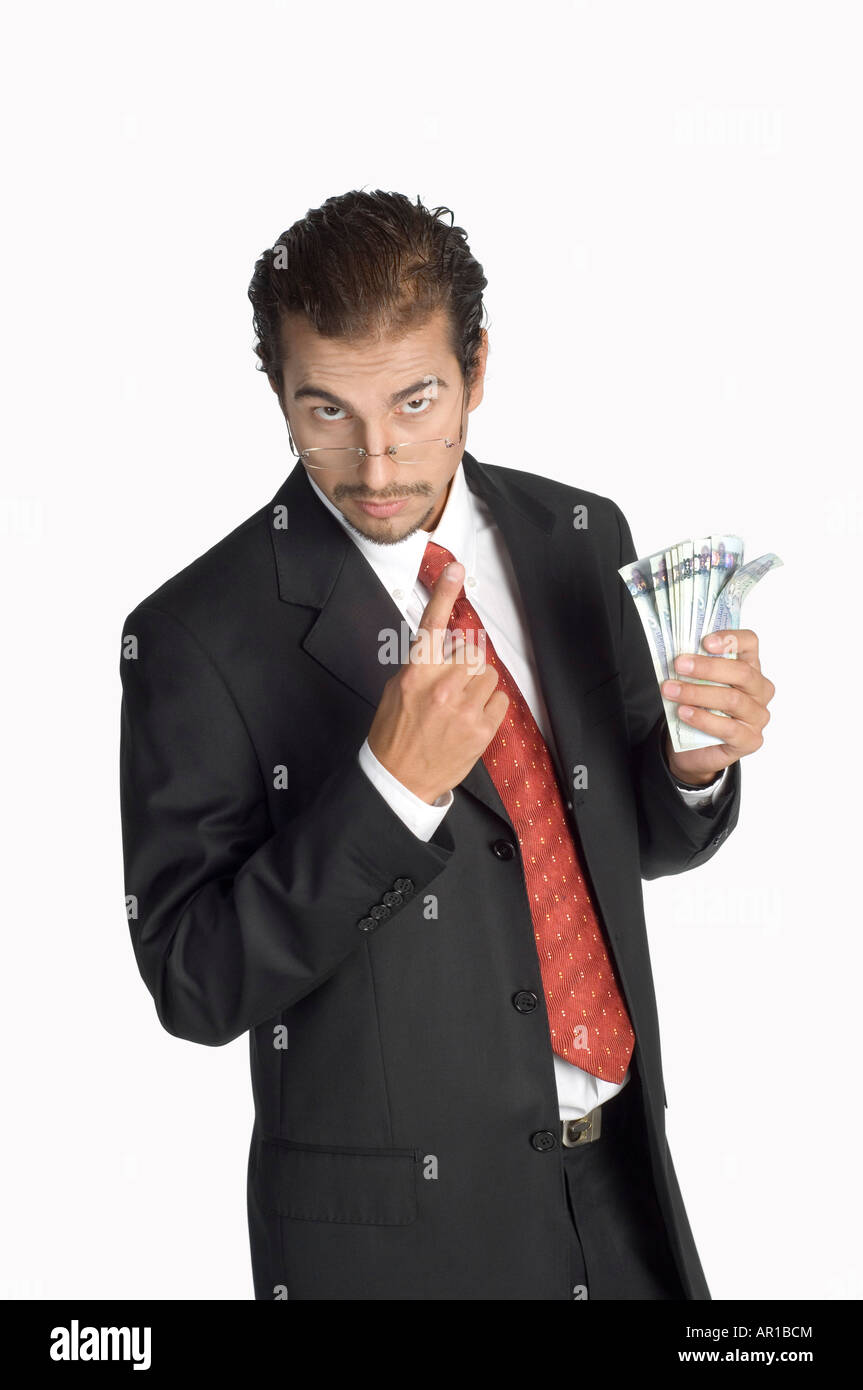 Businessman holding money, portrait Stock Photo - Alamy