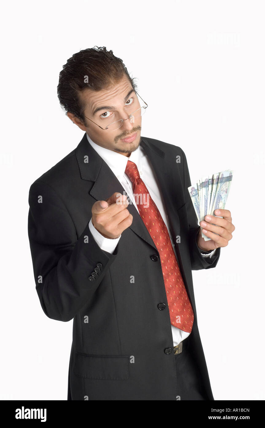 Businessman holding money, portrait Stock Photo - Alamy