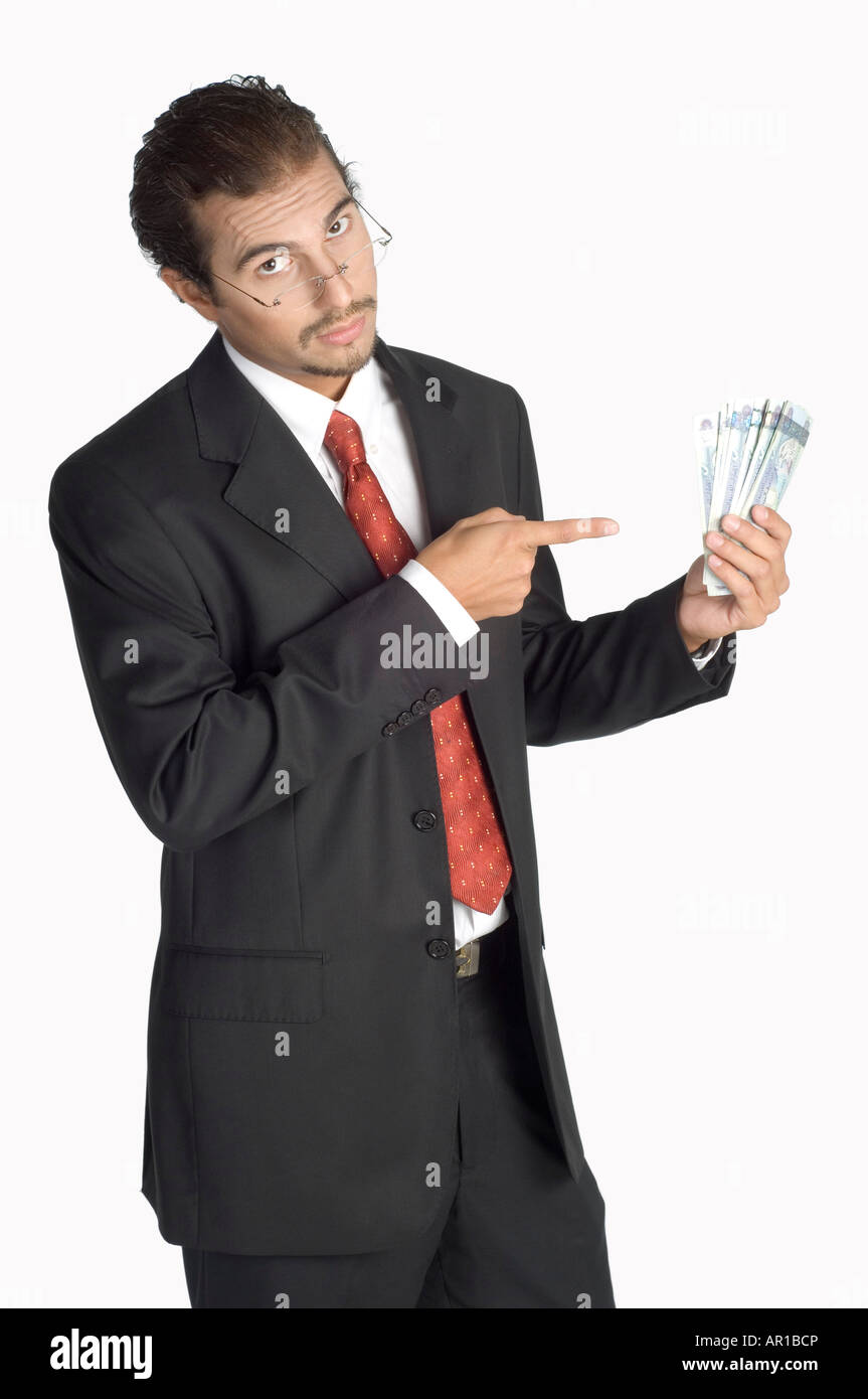 Businessman holding money, portrait Stock Photo - Alamy