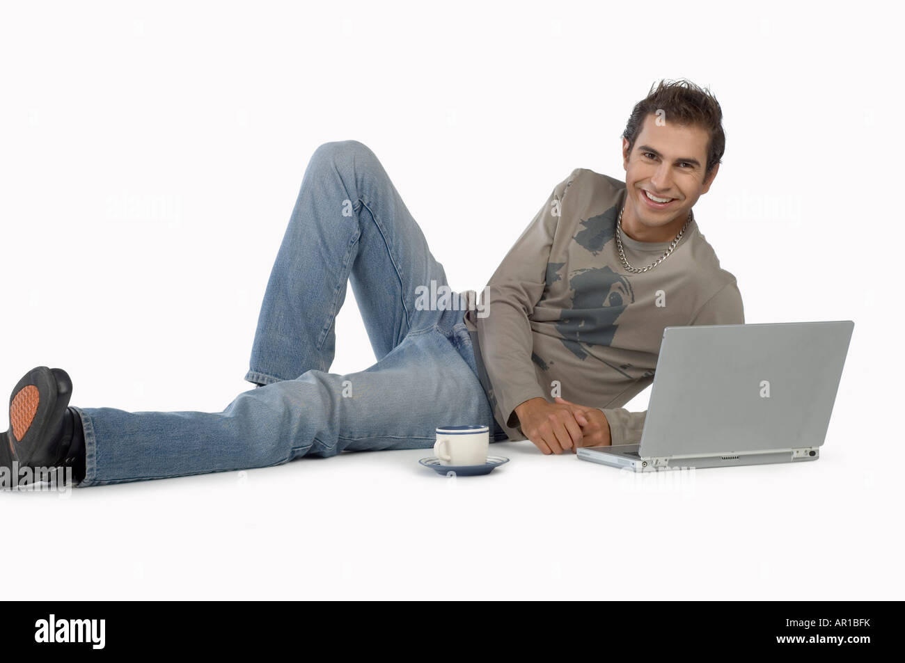 Young man with laptop, smiling, portrait Stock Photo - Alamy