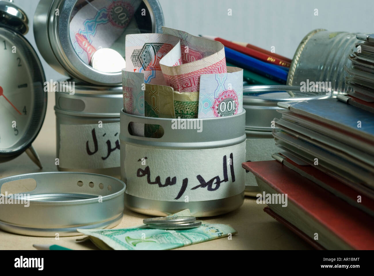 Money in containers, close-up Stock Photo - Alamy