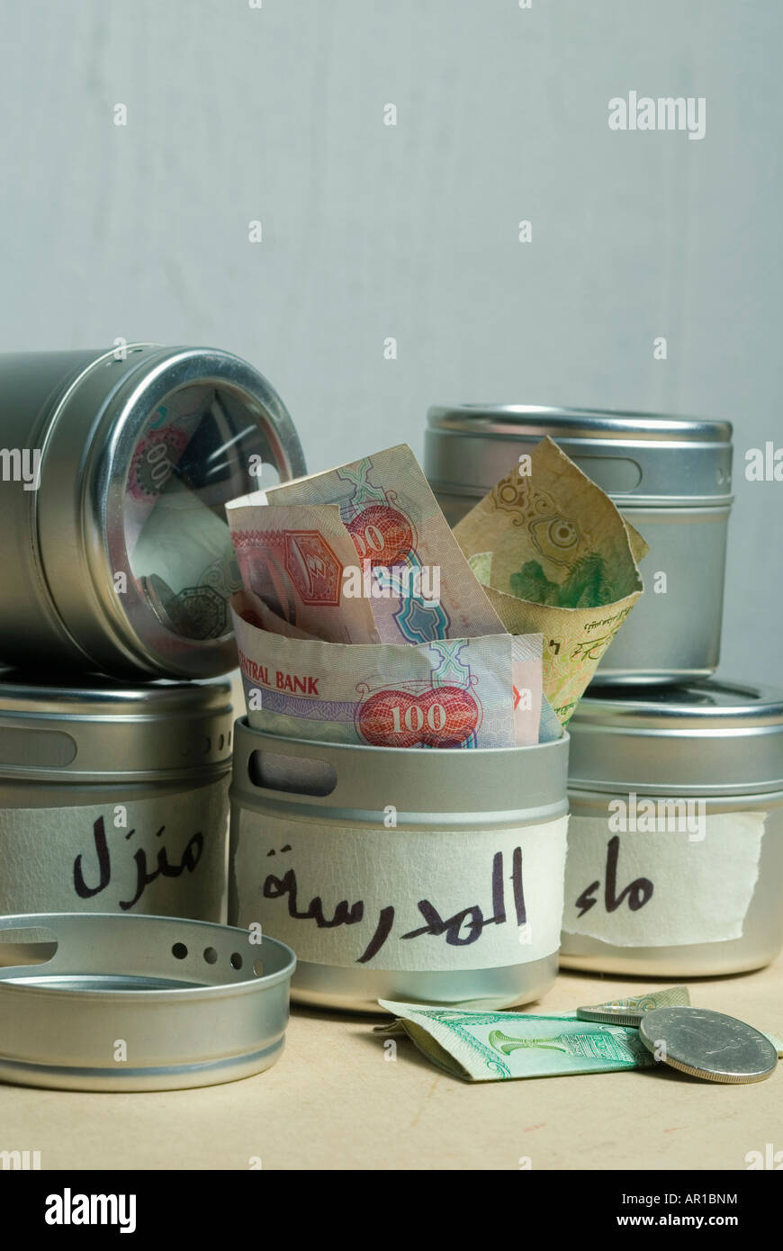 Money in containers, close-up Stock Photo - Alamy