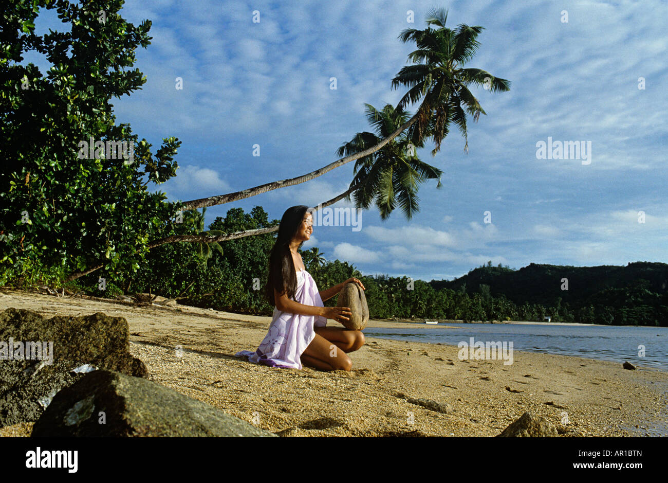 A beautful lady holds the Coco-de-Mer fruit. The fruit of this flower ...