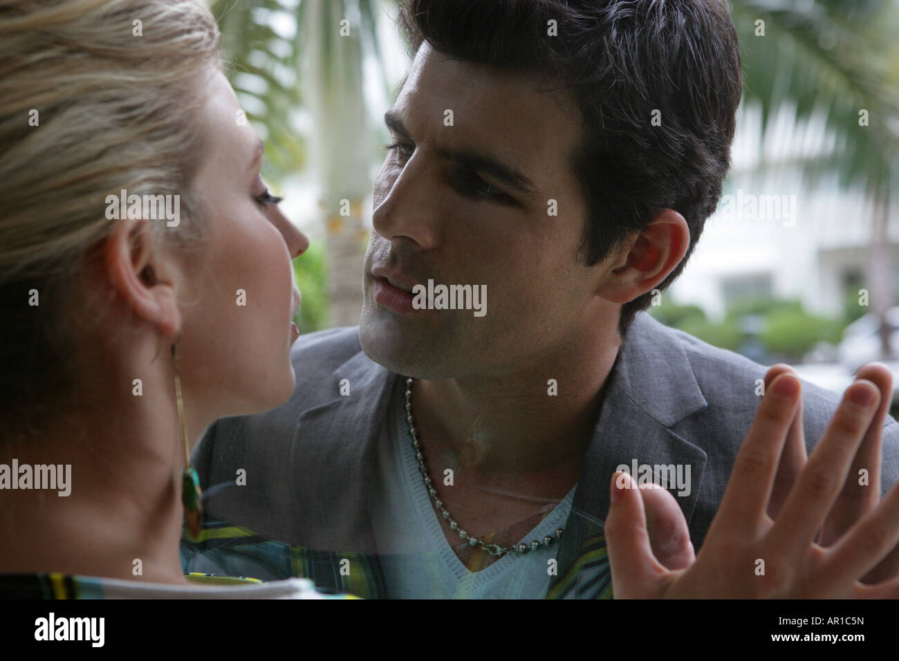 Couple kissing through glass window Stock Photo - Alamy