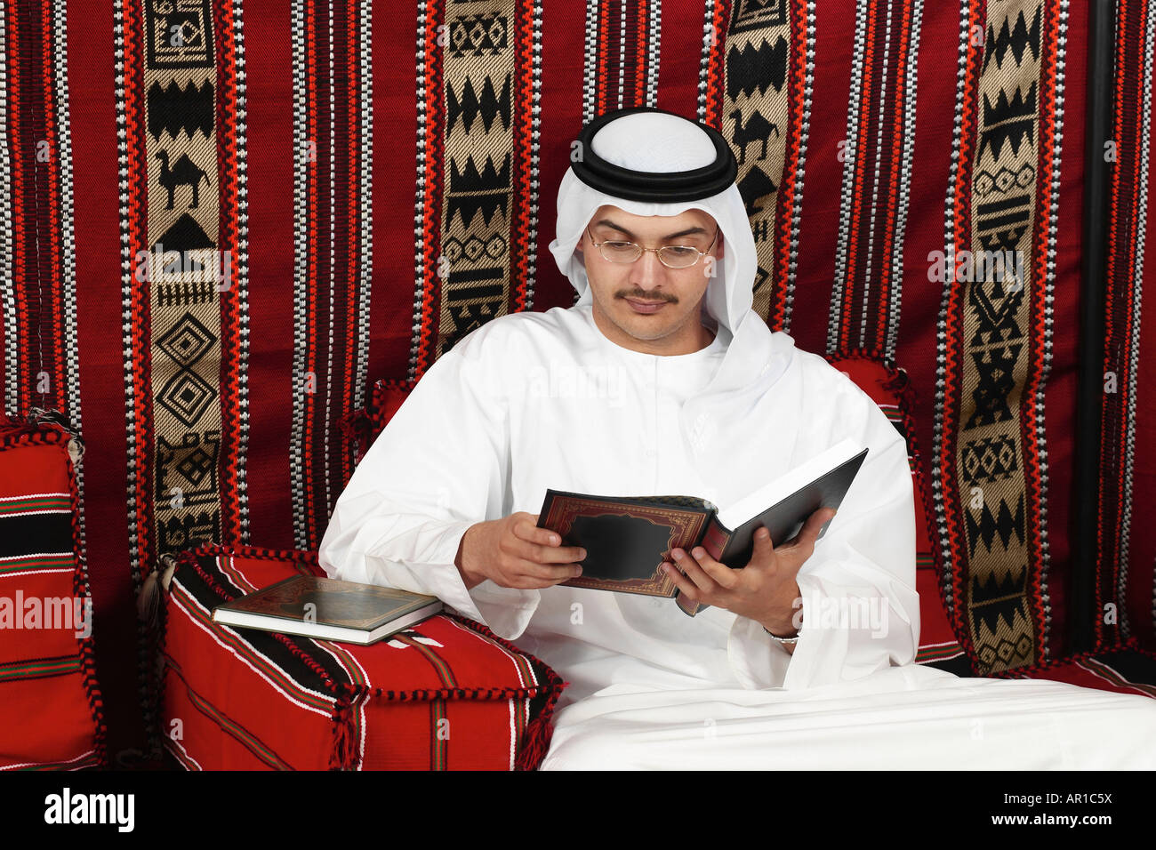 Arab man reading a book Stock Photo - Alamy