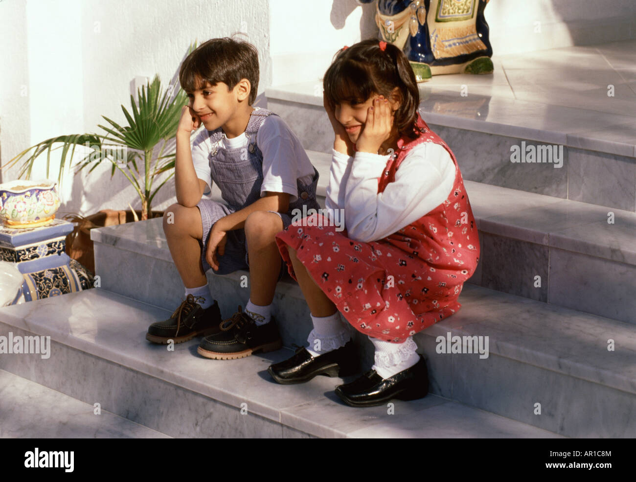 Children on the steps waiting Stock Photo - Alamy
