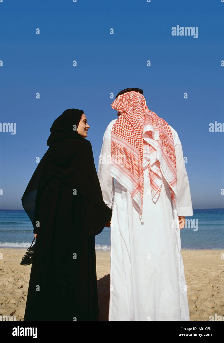 Arab couple on the beach Stock Photo - Alamy