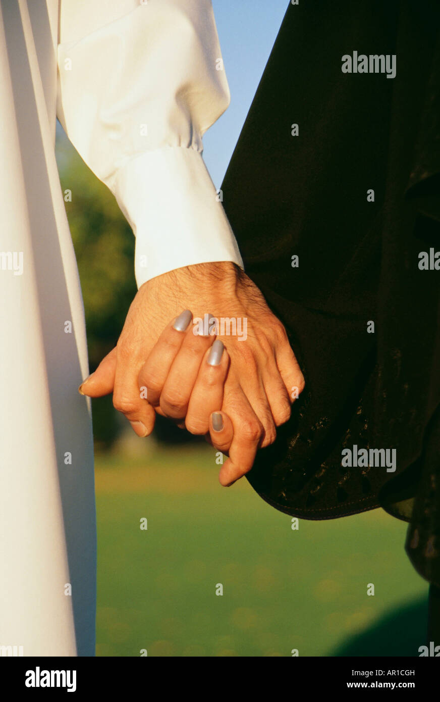 Couple clasping hands hi-res stock photography and images - Alamy