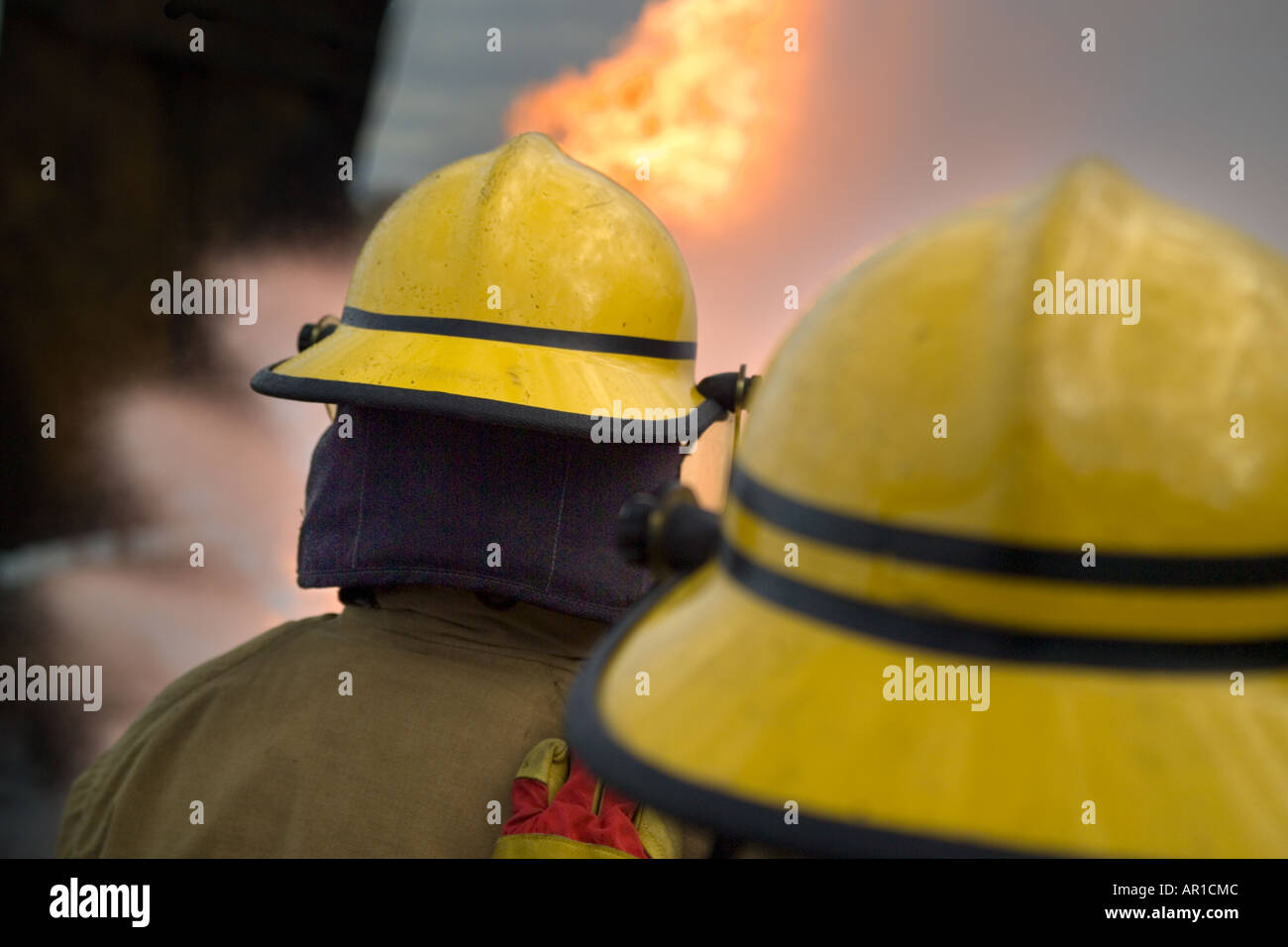 Fireman behind flames hi-res stock photography and images - Alamy