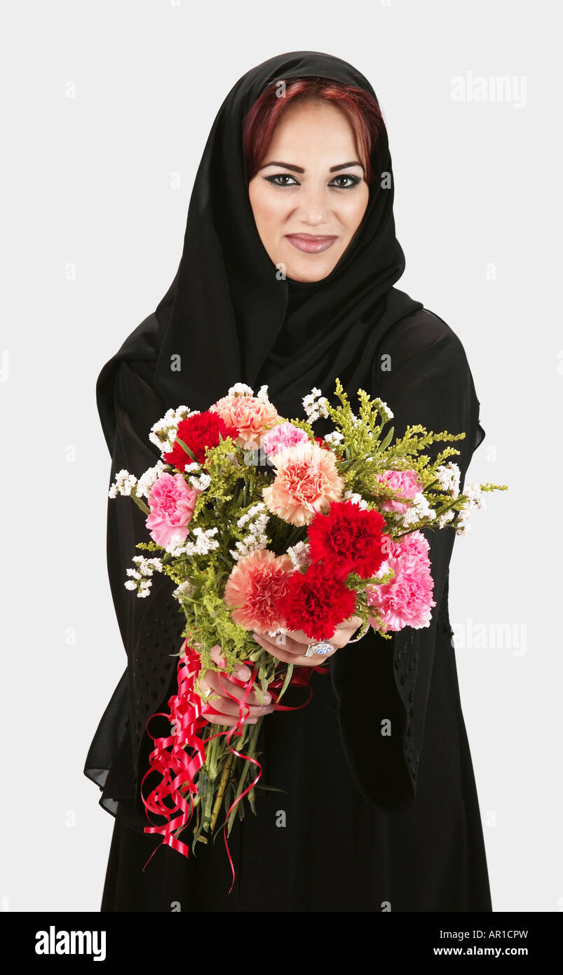 Arab lady with a boquet of flowers Stock Photo - Alamy