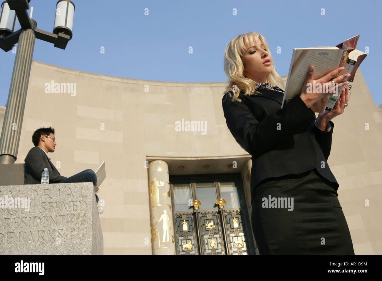 woman reading a book standing outside Stock Photo - Alamy