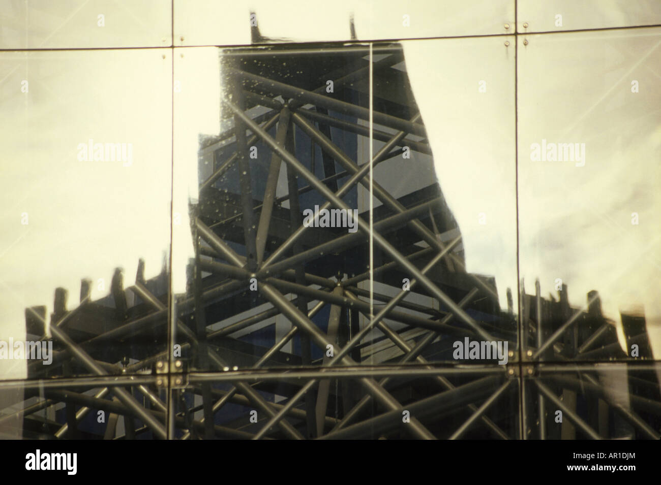 The shape of a building is reflected in the glass facade of another ...