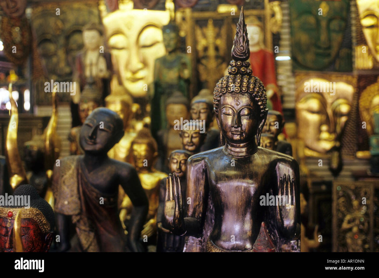 Buddha statues stand for sale at a market stall in Bangkok, Thailand ...