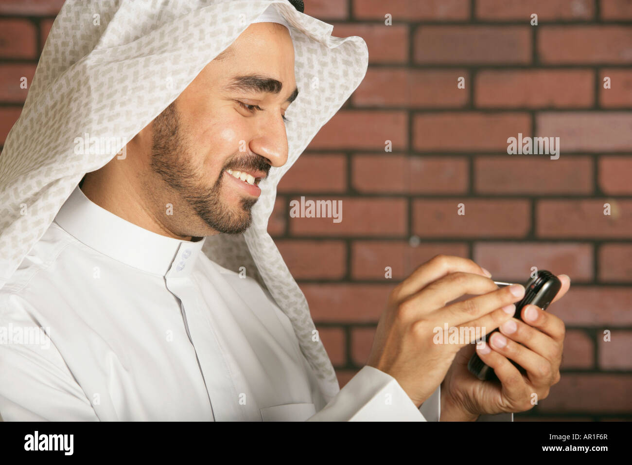 Arab Man busy on his mobile phone Stock Photo - Alamy