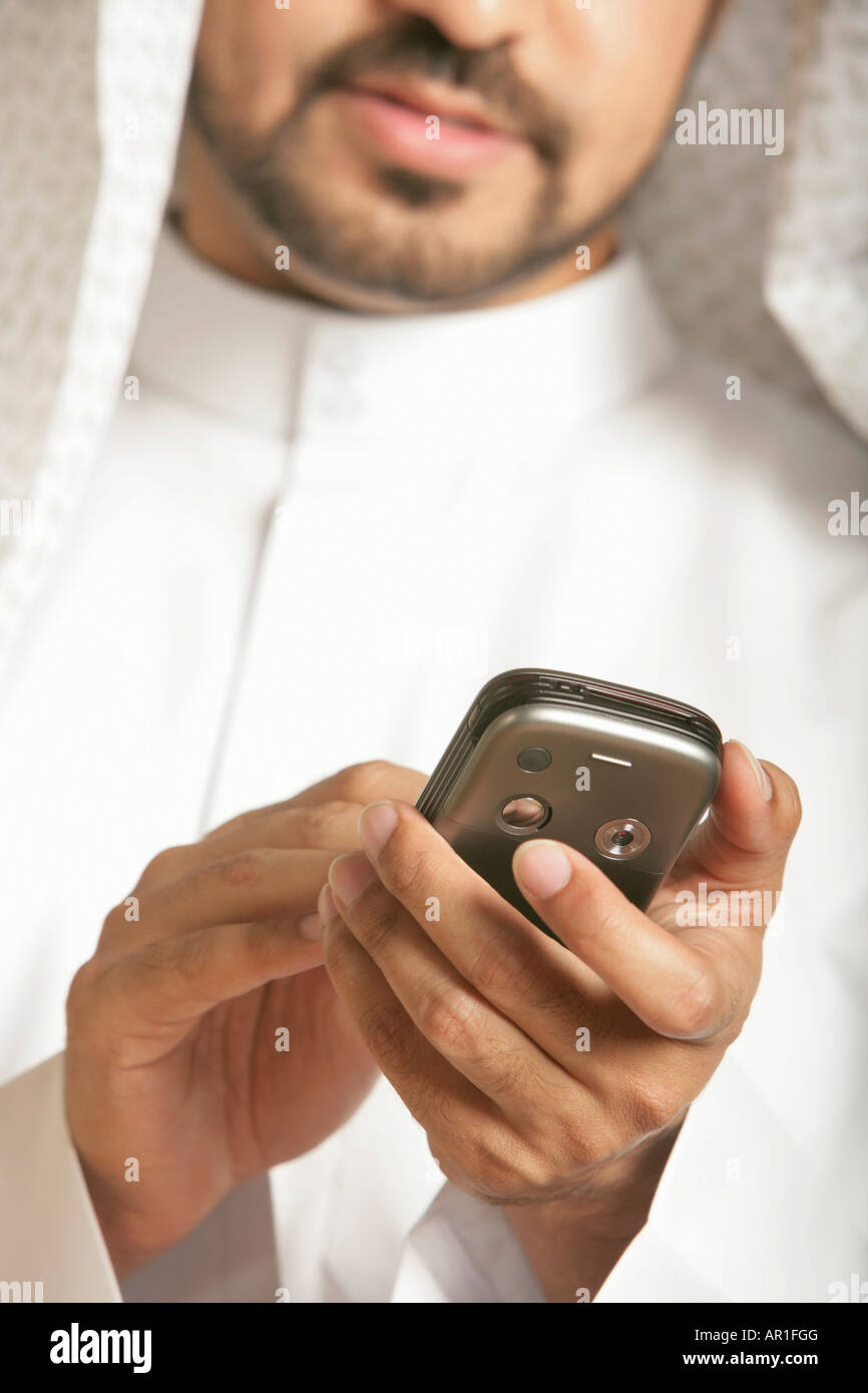 Arab Man busy on his mobile phone Stock Photo - Alamy