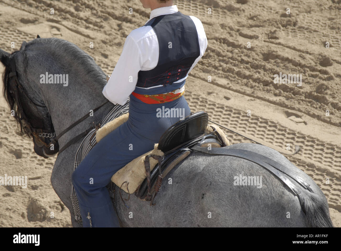 Back view of a young man riding with elegance and technique By Nano ...