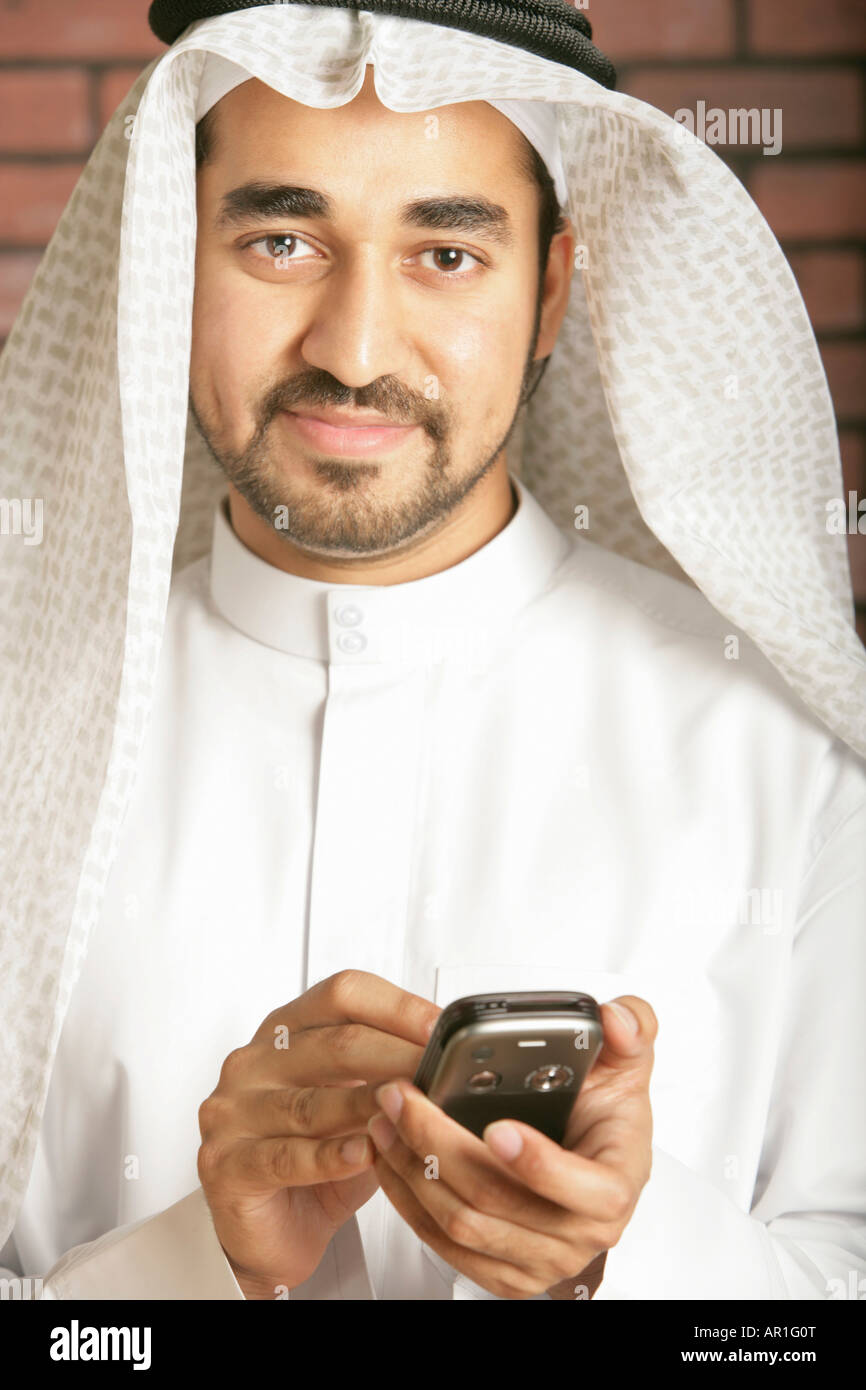 Arab Man busy on his mobile phone Stock Photo - Alamy