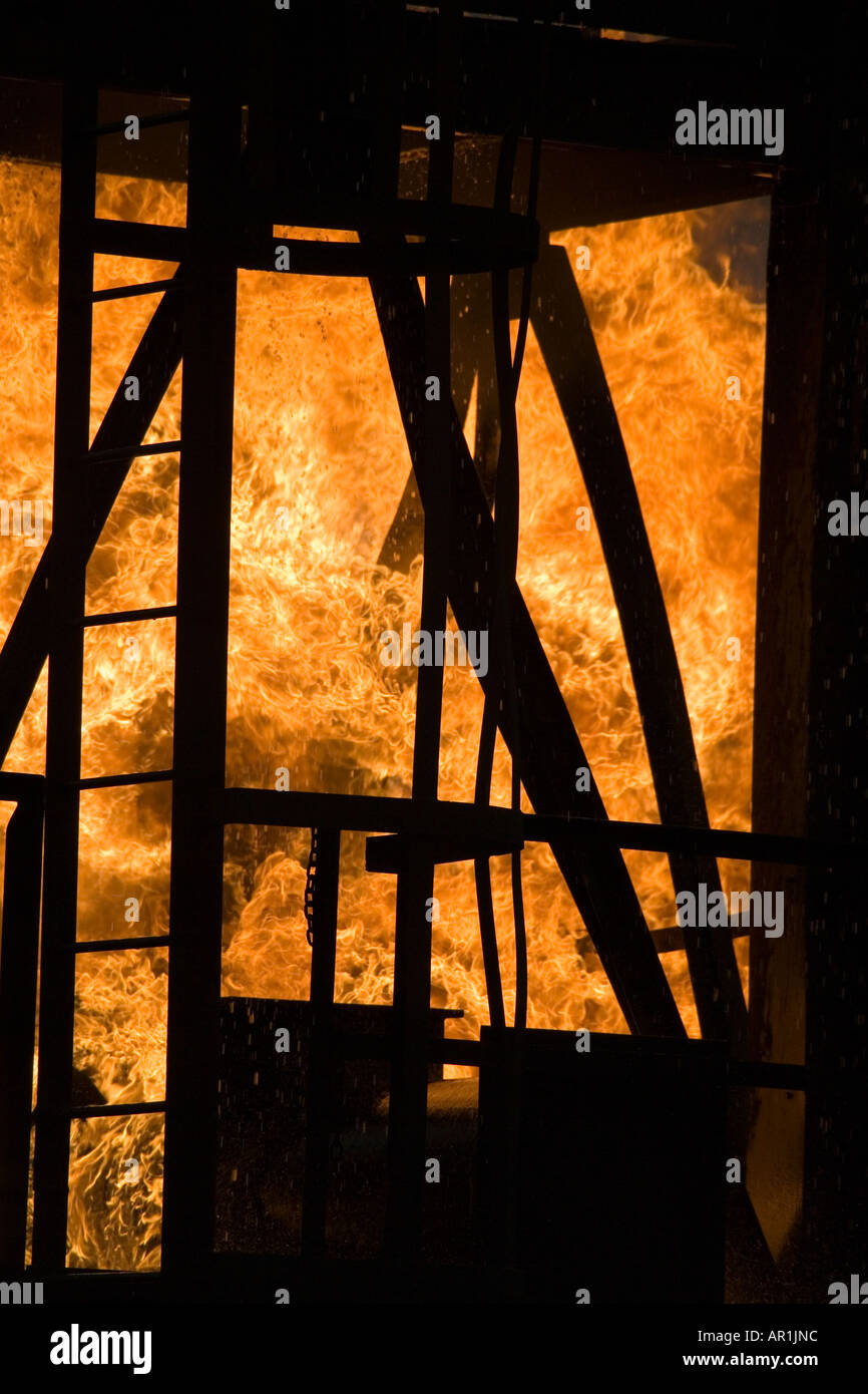 intense roaring out of control fire in side industrial building Stock ...