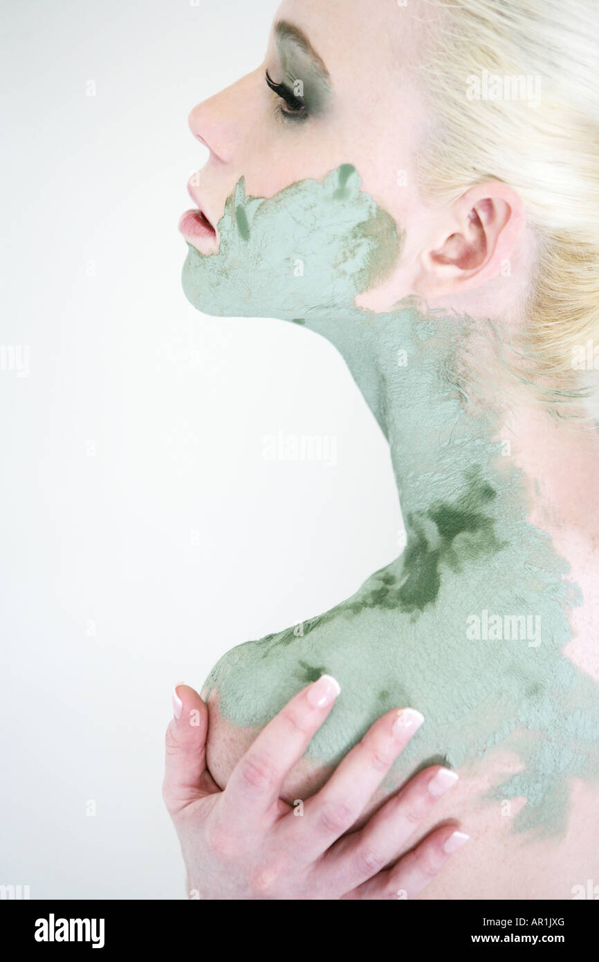 Side view of a woman wearing a green mask on her face, neck and ...