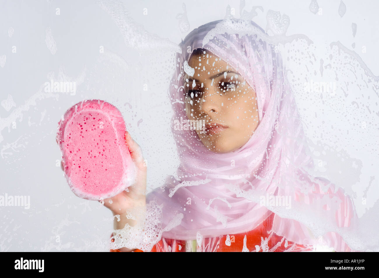 Lady Cleaning glass with soap Stock Photo - Alamy