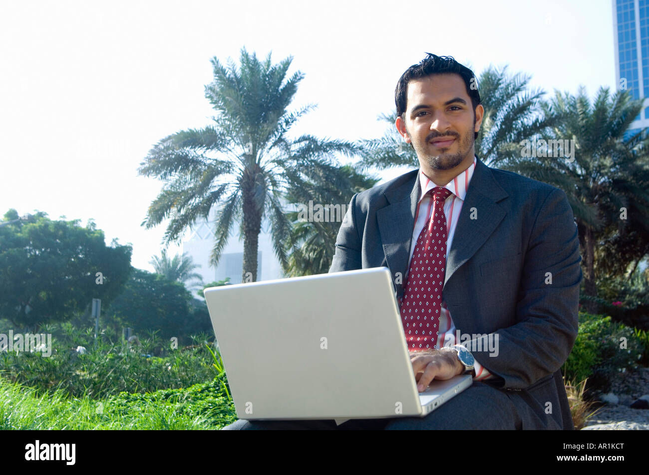 Young man with a laptop computer outdoors Stock Photo - Alamy