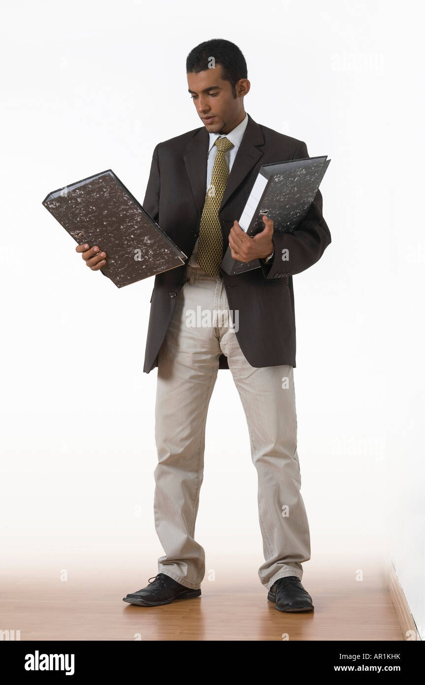 Young man holding files Stock Photo - Alamy